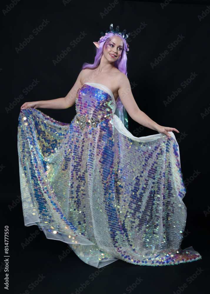 Full length portrait of beautiful female model with long purple hair ...