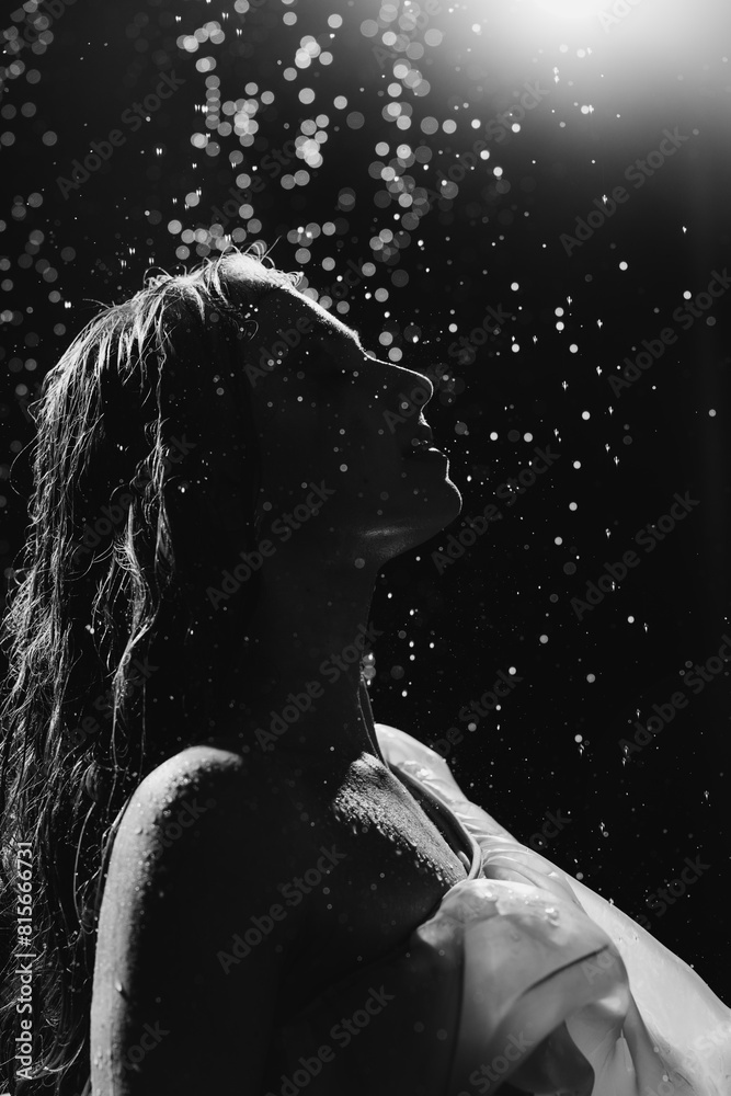 Portrait of teenager girl under falling water drops with wet face and ...