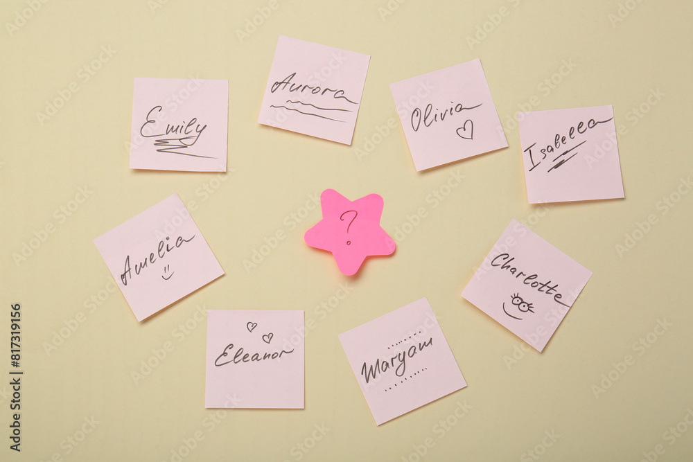 Choosing baby name. Paper stickers with different names and question ...