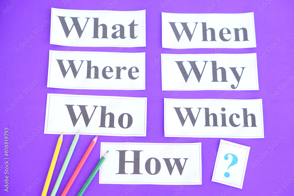 Paper cards with Wh-question words and question marks on purple ...