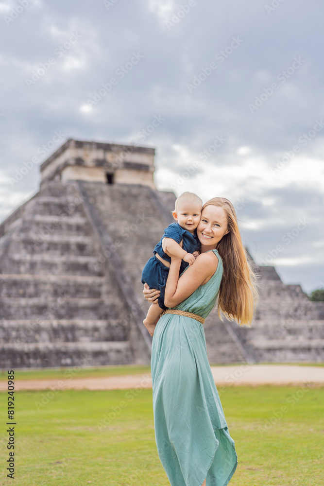 Beautiful tourist woman and her son baby observing the old pyramid and ...