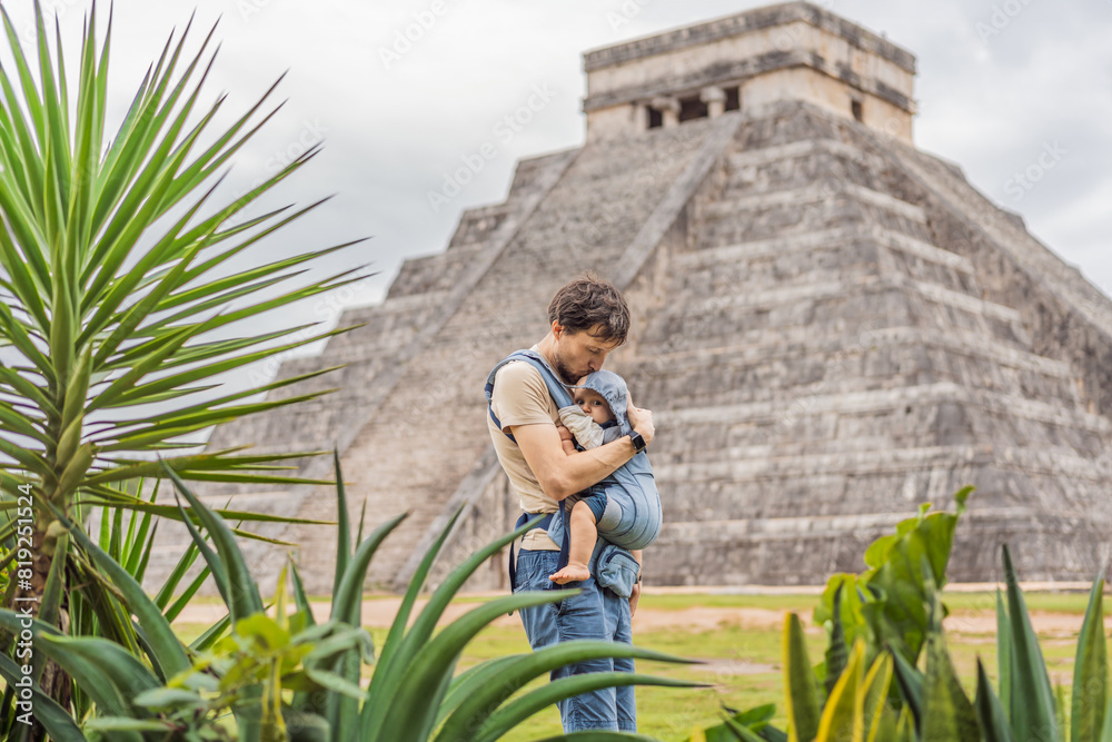 Father and son tourists observing the old pyramid and temple of the ...