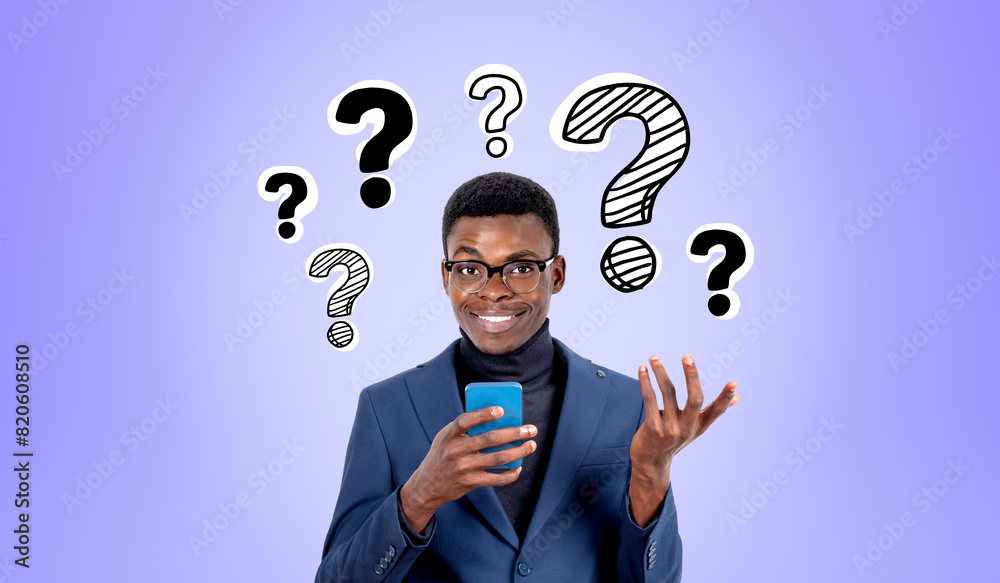 Black businessman using smartphone, hand gesture at question marks ...