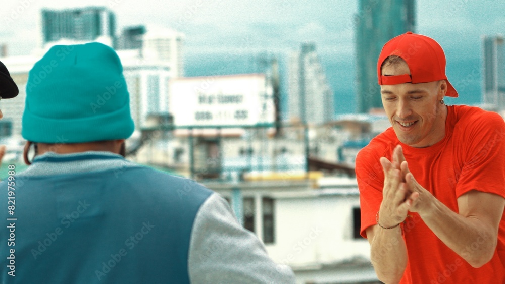 Professional caucasian rapper rap battle with partner at roof top ...