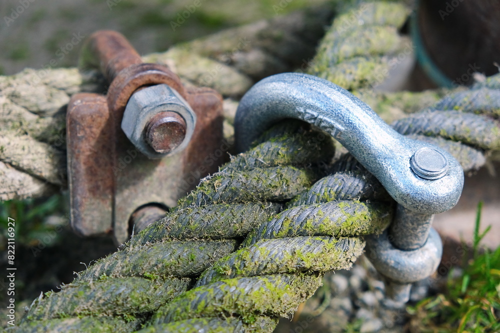 Screw pin anchor shackle and rope. Rusty rigging. Time flow. Mooring of ...