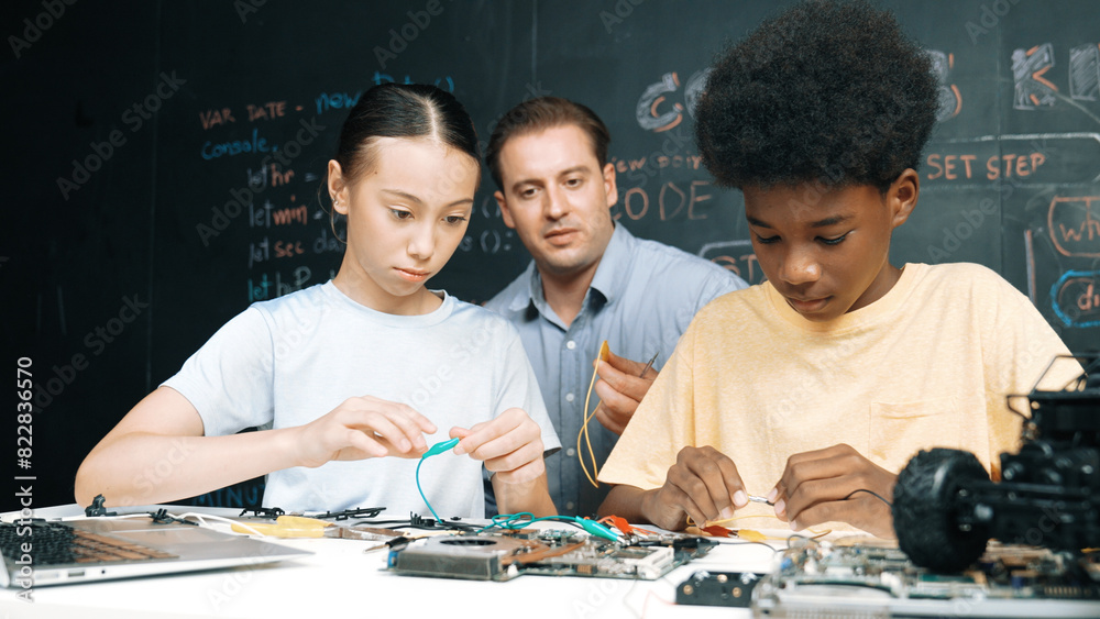 Smart mentor teach main board construction while diverse teenager ...