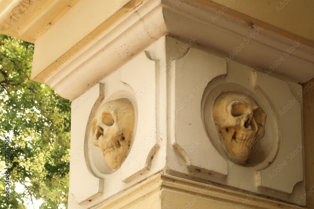 Two skull carvings, sculptures, reliefs on a pillar, column, facade of ...