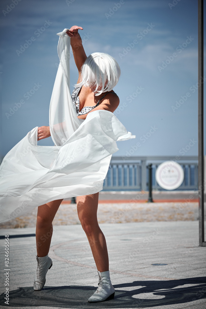 Young sexy girl in space silver micro skirt dancing with white silk ...