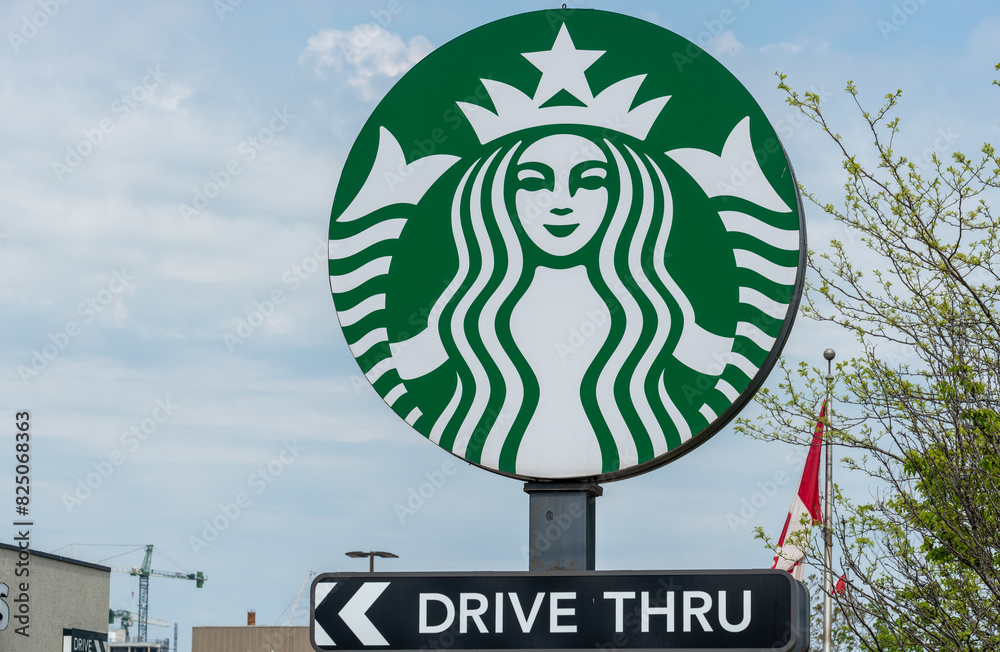 round roadside sign of Starbucks, a coffee shop chain, located here at ...