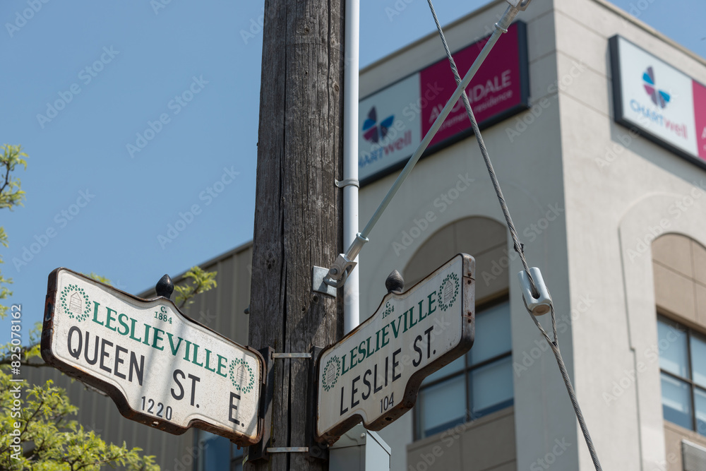 City of Toronto street signs at the corner of Queen Street East and ...