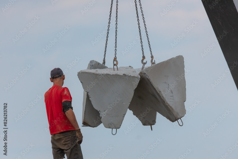 Loading and transporting dragon teeth for defense. Concrete pyramids ...