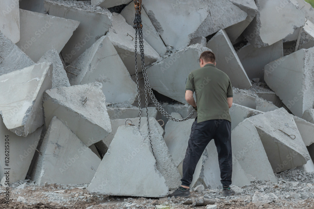 Loading and transporting dragon teeth for defense. Concrete pyramids ...