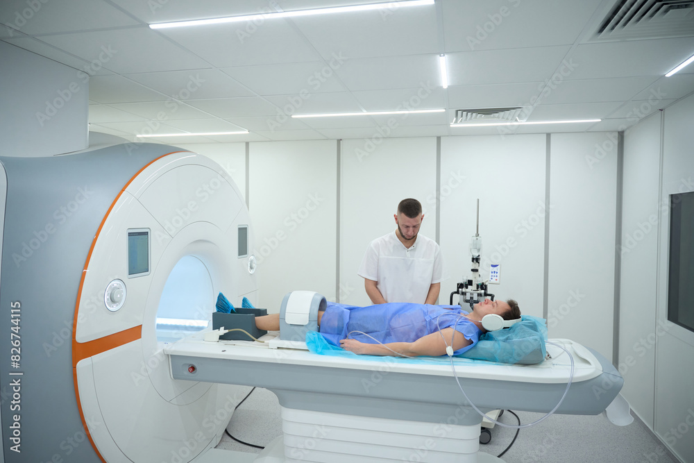 Healthcare professional preparing patient for lower extremity MRI Stock ...