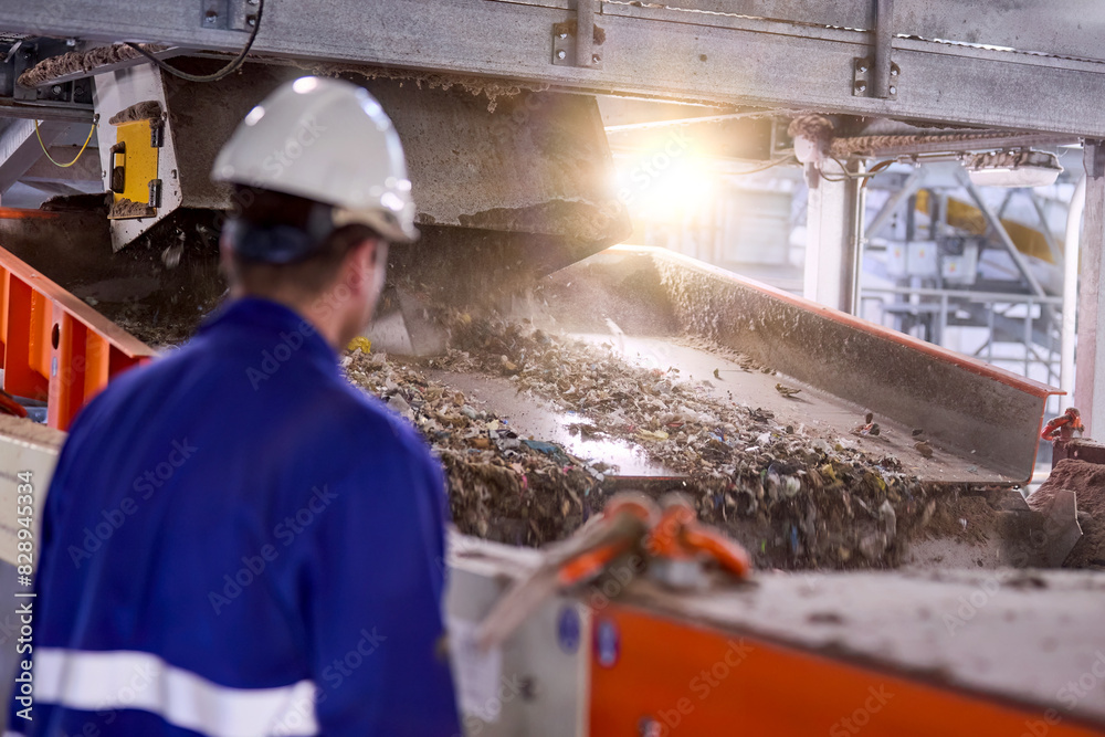 Worker overseeing the sorting and processing of refuse-derived fuel ...