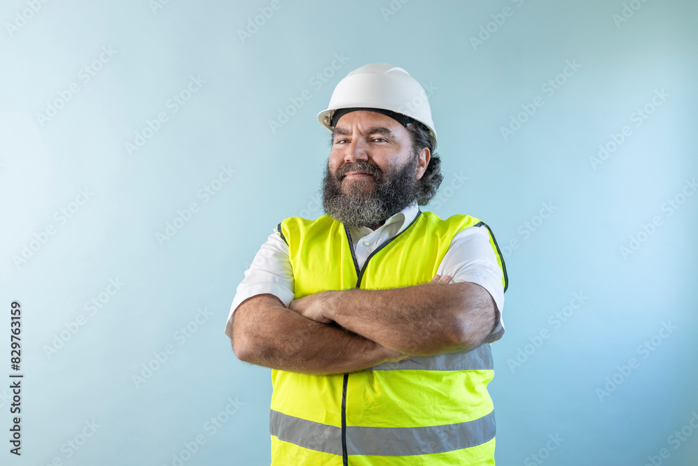smiling adult man engineer with beard and wearing helmet and safety ...