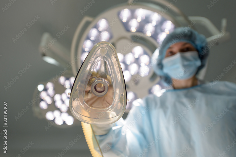 Anesthesiologist puts an oxygen mask on the patient. Preparing for ...