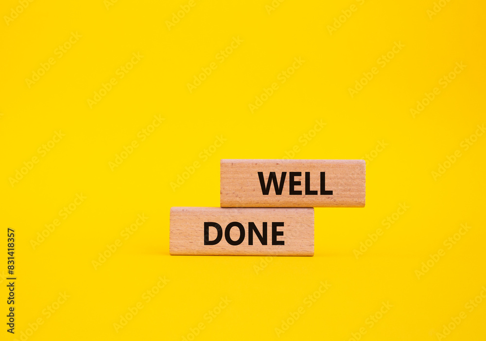 Well done symbol. Wooden blocks with words Well done. Beautiful yellow ...