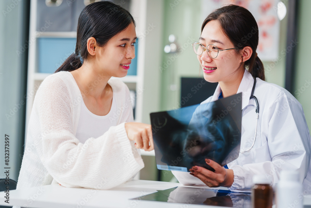 Asian female doctor specializing in psychiatry works at her desk ...