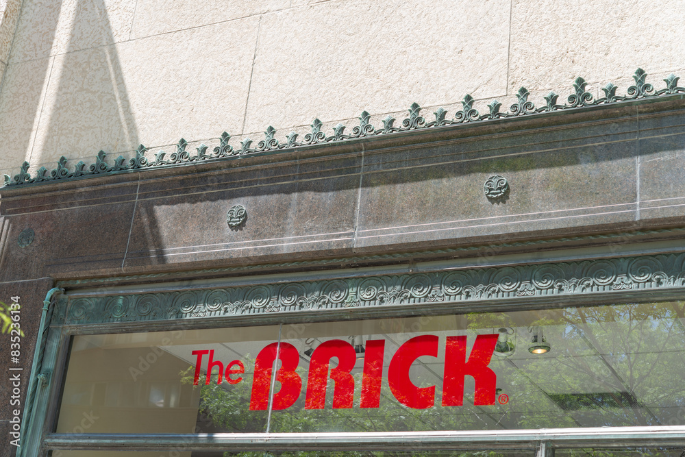 exterior facade and sign of The Brick, a furniture store, located at ...