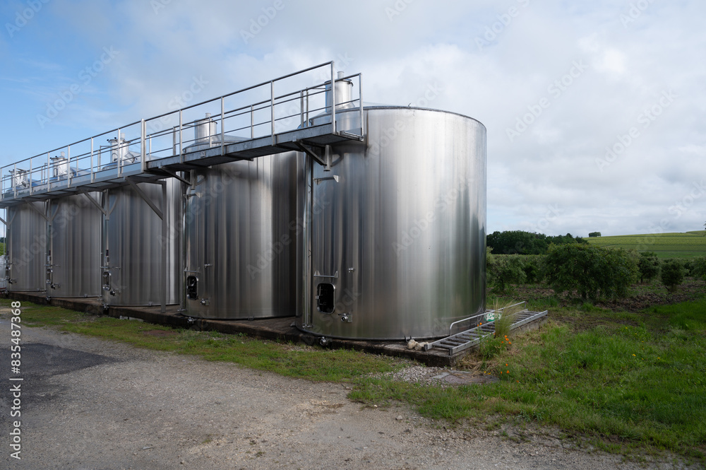 Works at distillery in Cognac white wine region, Charente, steel tanks ...