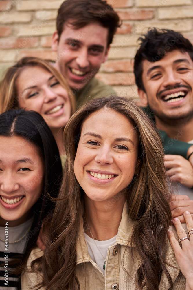 Vertical. Multiracial group of friends outdoors posing smiling and fun. International students ...