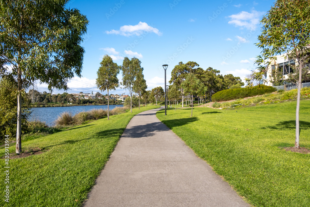 A pedestrian walkway, footpath, or walking trail in a public green park ...