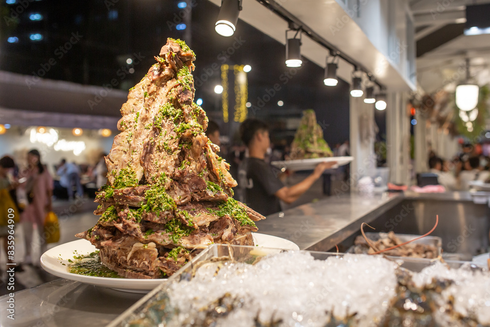 A stack of ribs presented at a counter at Jodd Fairs Night Market in ...