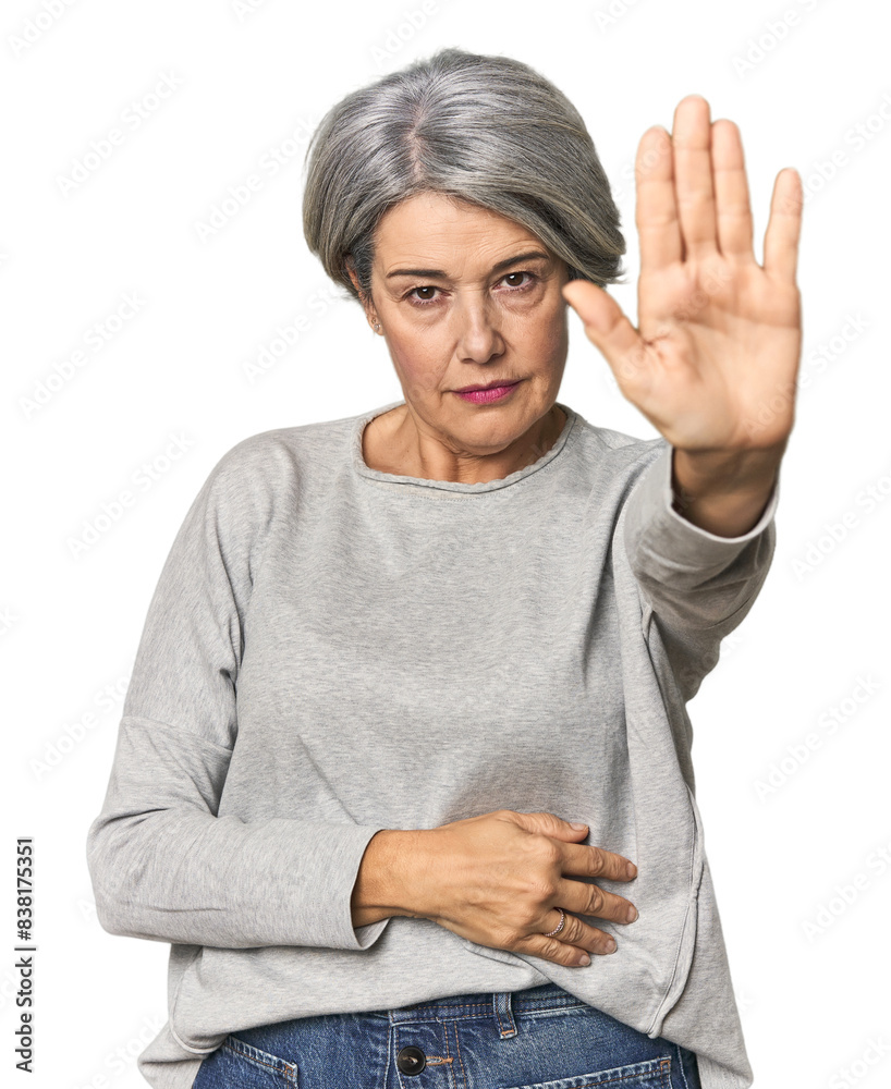 Caucasian mid-age female on studio background standing with ...