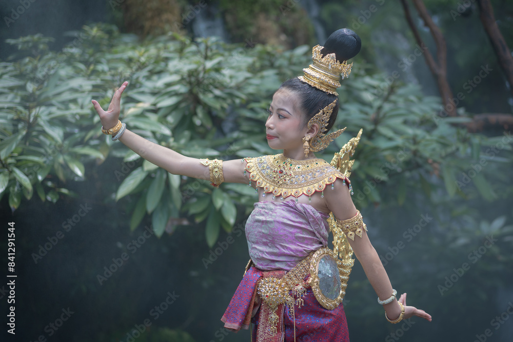 Beautiful girl in a Kinnari dress in green natural with the moss and ...