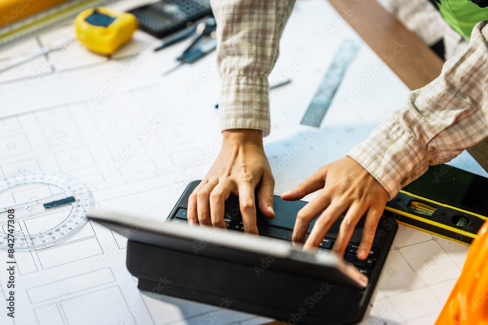 Female architect engineer is drafting blueprints using CAD software ...