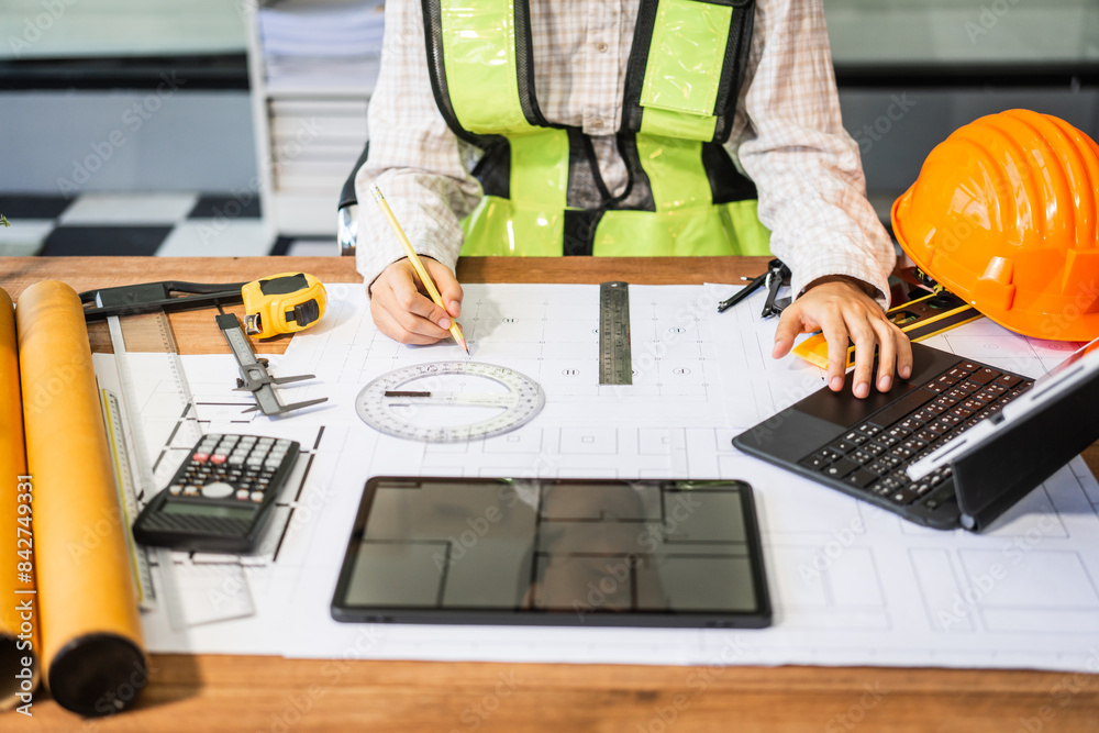 Female architect engineer is drafting blueprints using CAD software ...