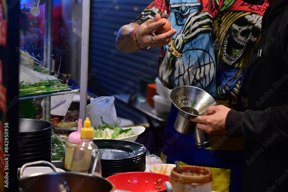 Street food cooking in a small stall along side the road in bangkok ...