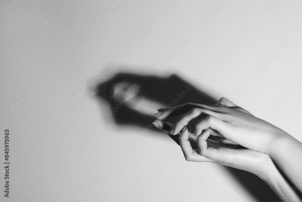 Shadow puppet. Woman making hand gesture like crocodile on light ...