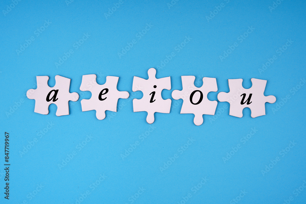 Communication, learning and education concept. The vowels aeiou written ...