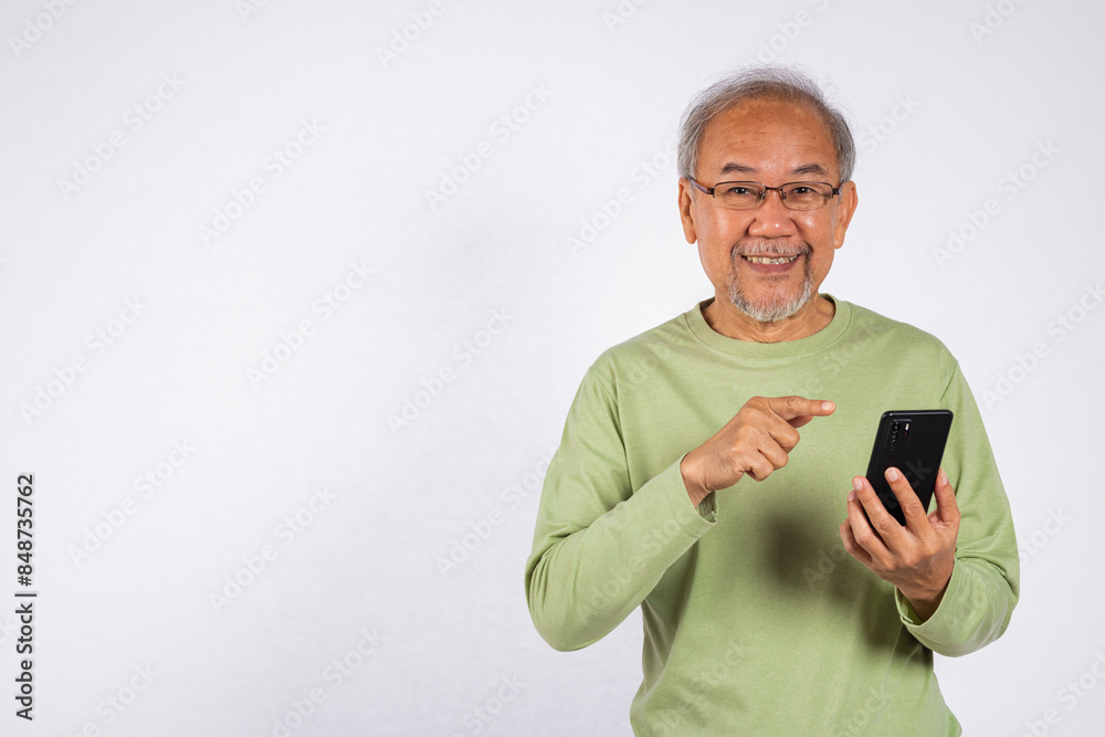 Portrait smiling Asian older man smiling and pointing at his cell phone ...