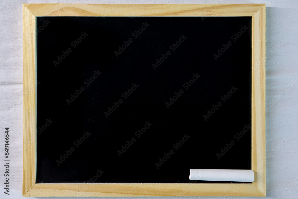 Black school blackboard and chalk next to it. Top view. For backgrounds ...