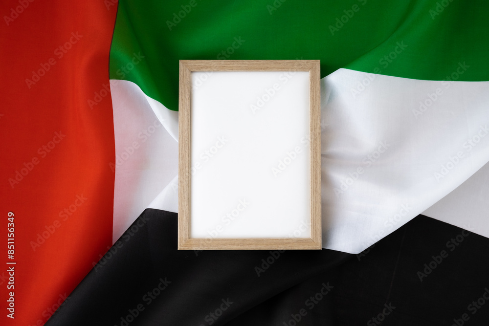 Empty white paper frame Small flag of UAE on beige background with ...