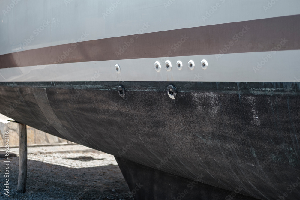 multihull catamaran hull boat body overhaul in dry dock on land, lifted ...