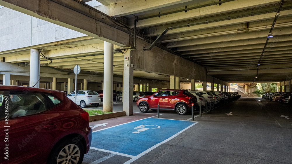Accessible parking space in a covered urban car park displaying marked ...