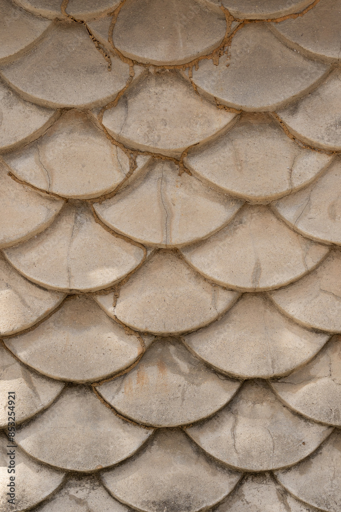 Up-close wall designed to resemble fish scales, gleaming under vibrant ...