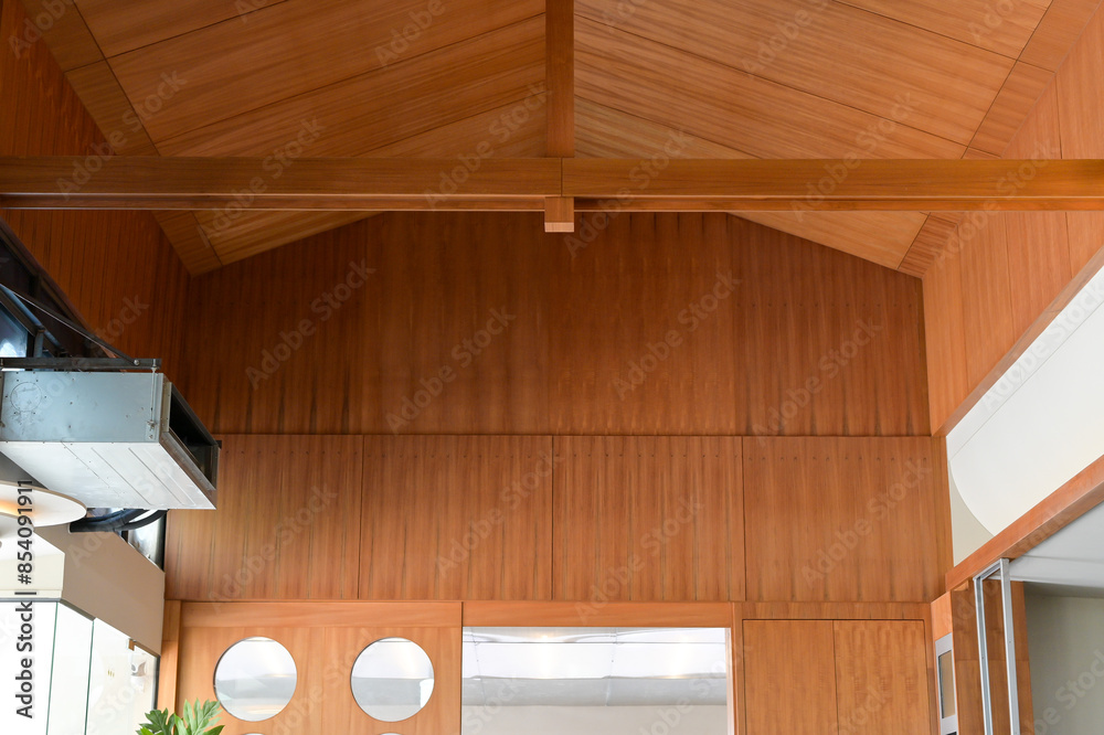 Close-up view of a modern HVAC duct system installed against a wooden ...