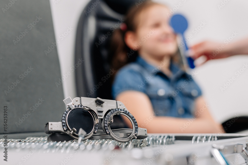 Cute baby testing visual acuity with one eye closed. Concept of ...