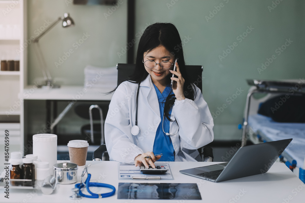Asian professional successful female doctor in white lab coat with ...