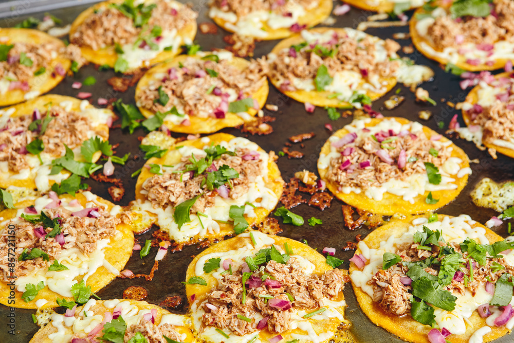 Frying tacos tortillas with cheese, onion, herbs and meat on griddle in ...