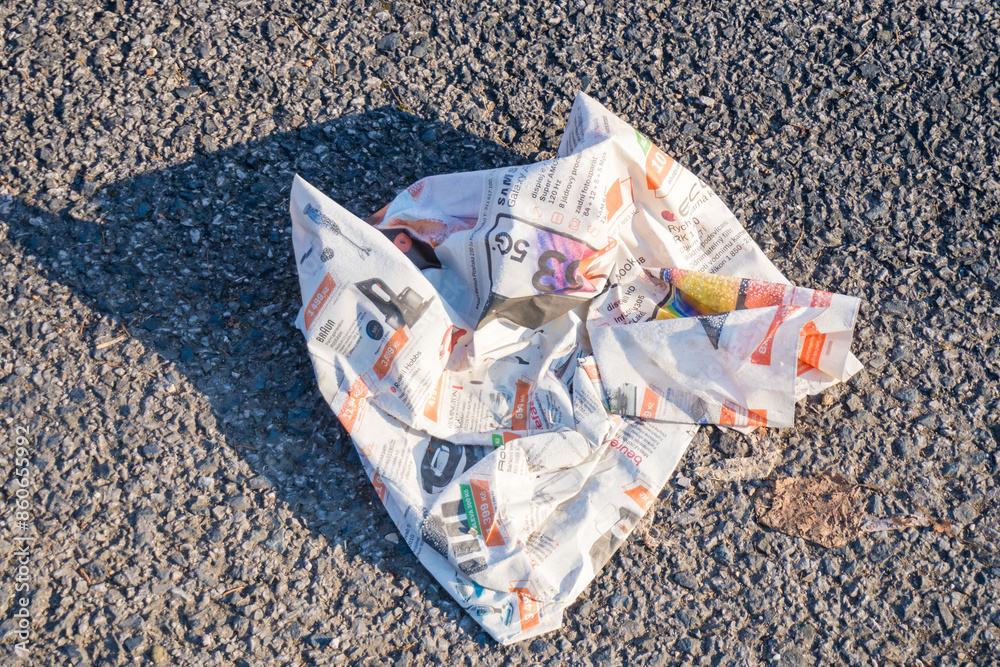 Old crumpled newspaper page laying on the street, on the asphalt Stock ...