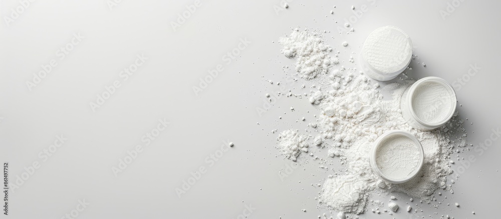 A collection of spilled baby powder containers on a blank white ...