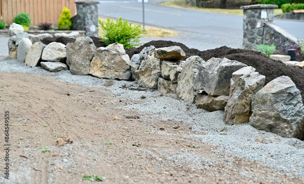 Yard garden landscaping project in progress, building rock borders ...