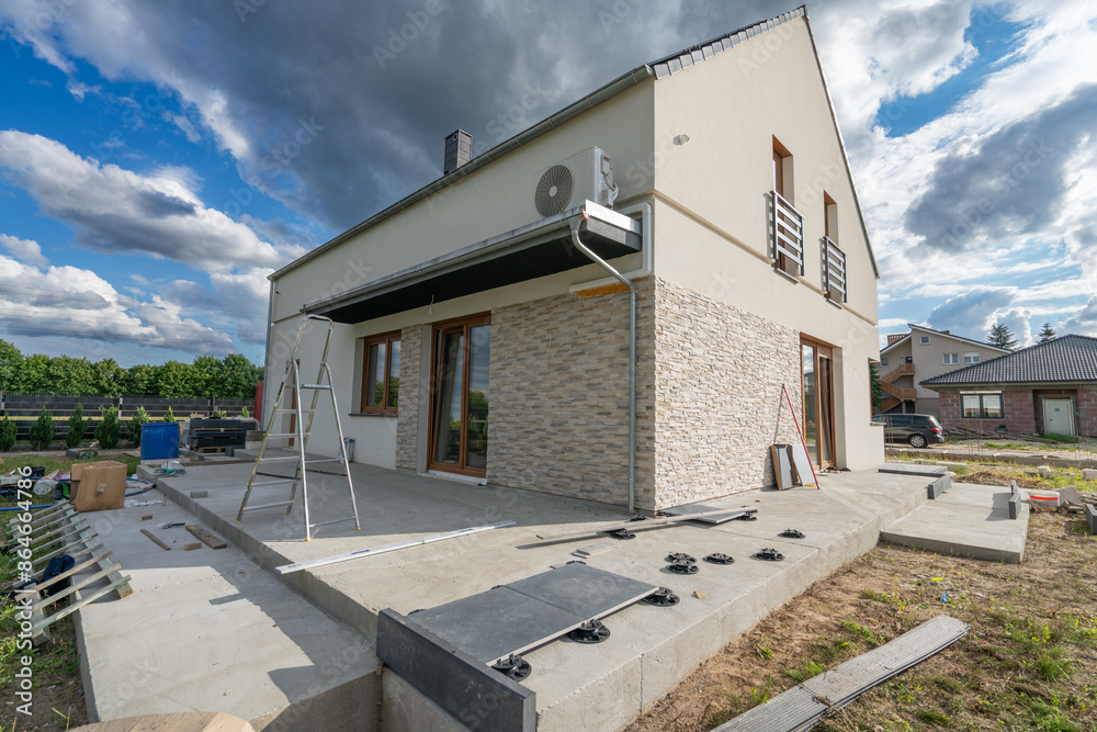 New build house with ceramic terrace tiles on adjustable supports under ...