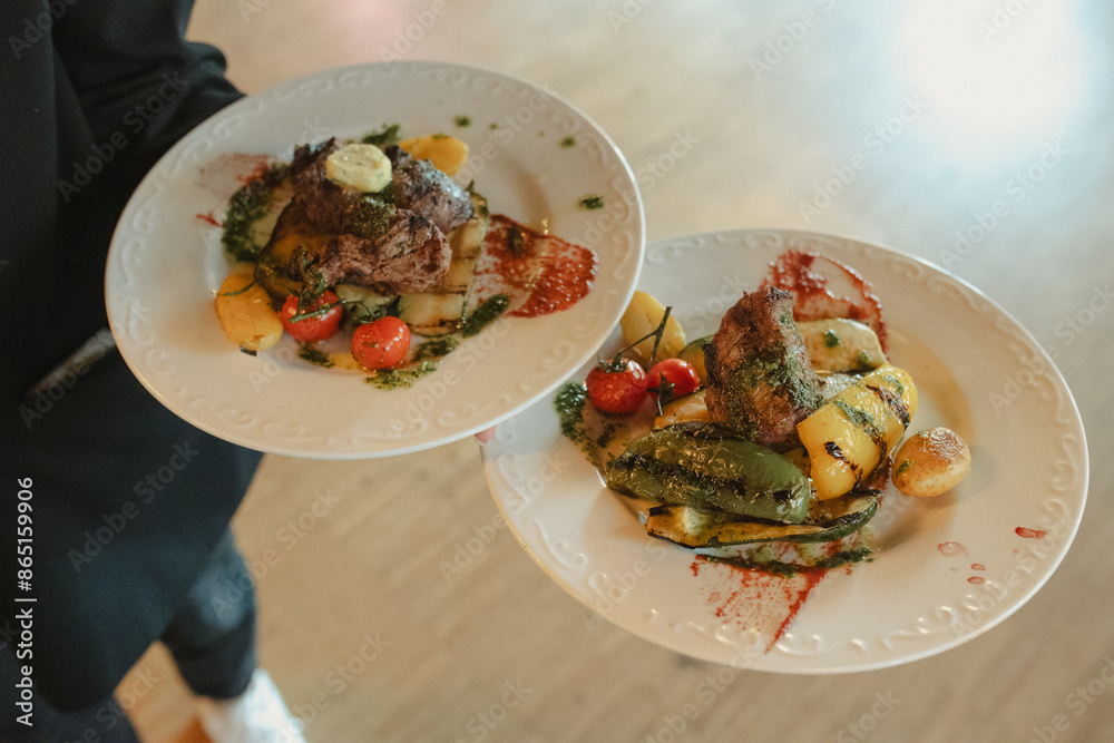 Two gourmet dishes served on white plates, featuring steak, roasted ...