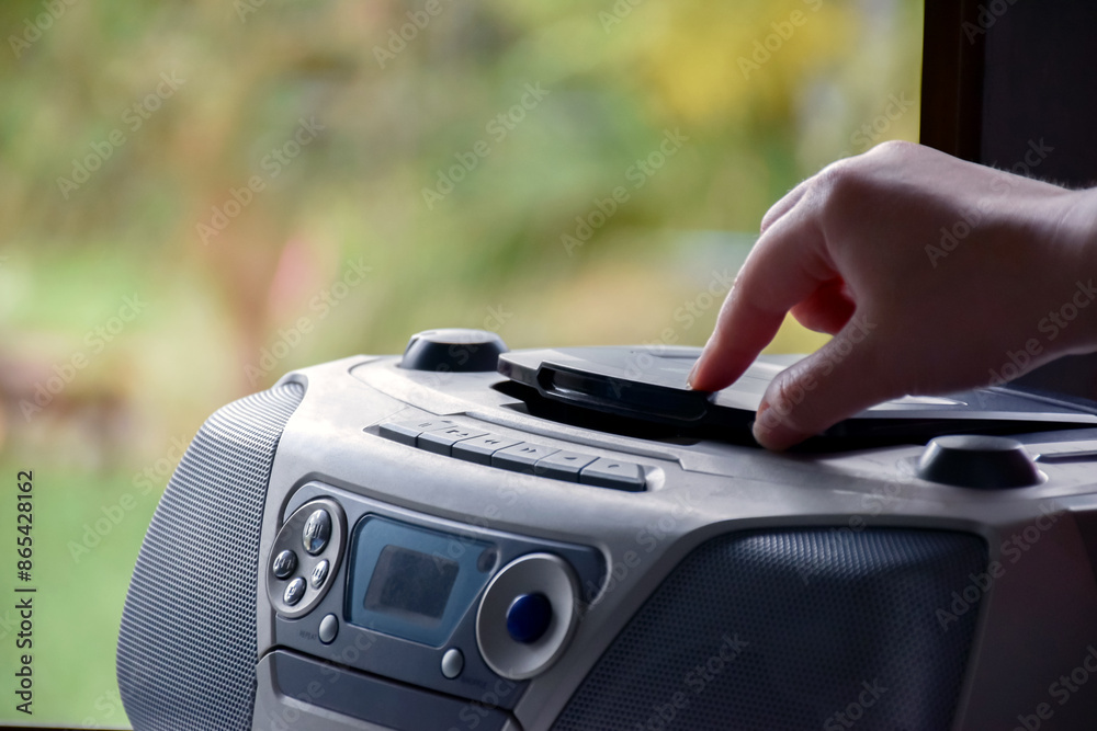 Homeowner is pushing the cd deck back into place with his fingers to ...